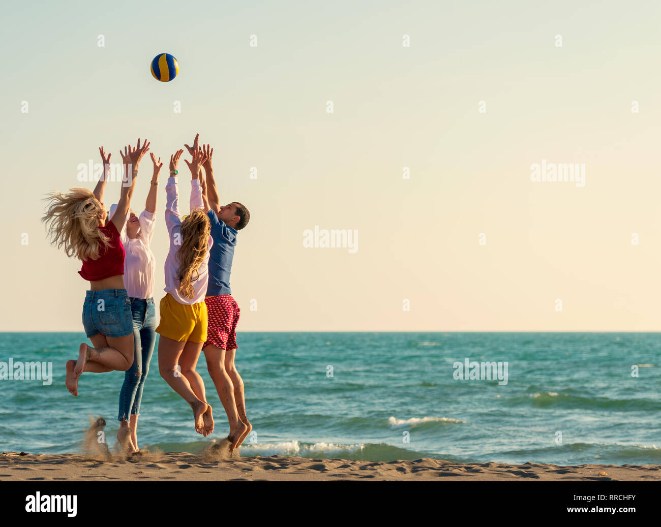 Group of friends enjoy on the beach Stock Photo - Alamy