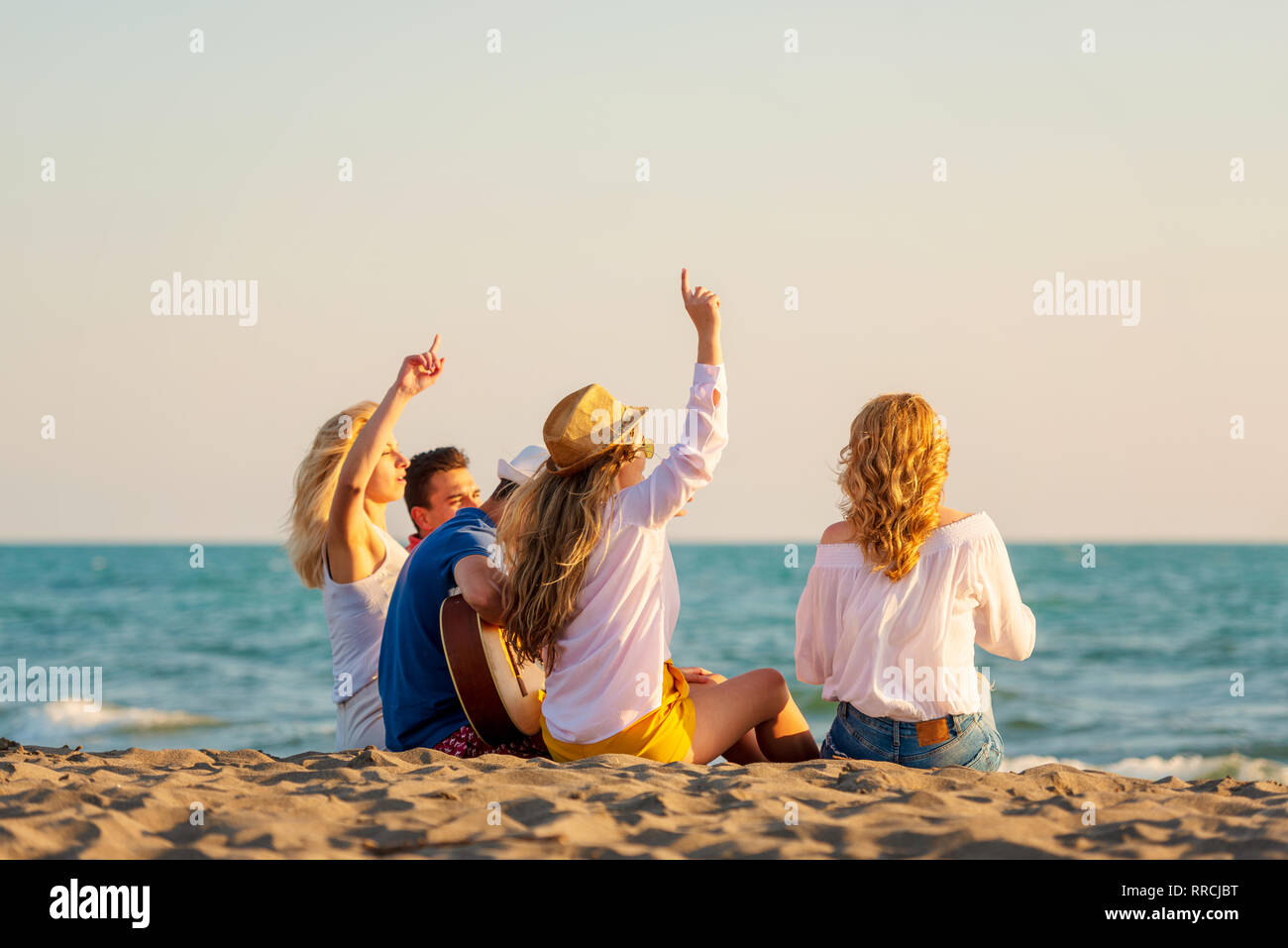 Group of friends enjoy on the beach Stock Photo - Alamy