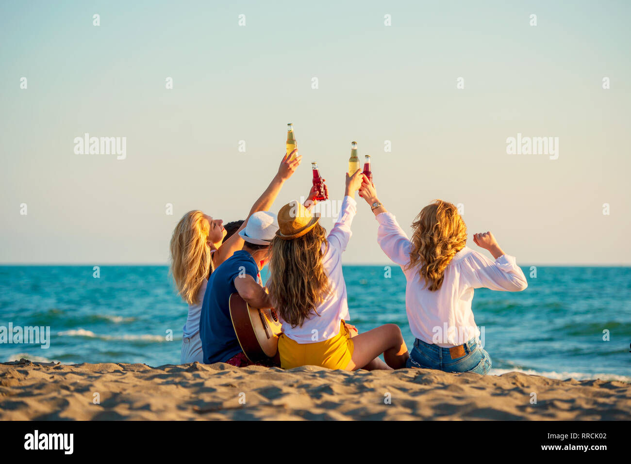 Group of friends enjoy on the beach Stock Photo - Alamy