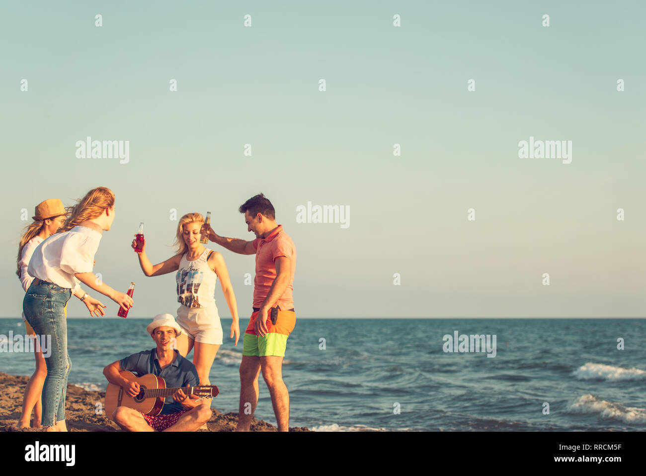 Group of friends enjoy on the beach Stock Photo - Alamy