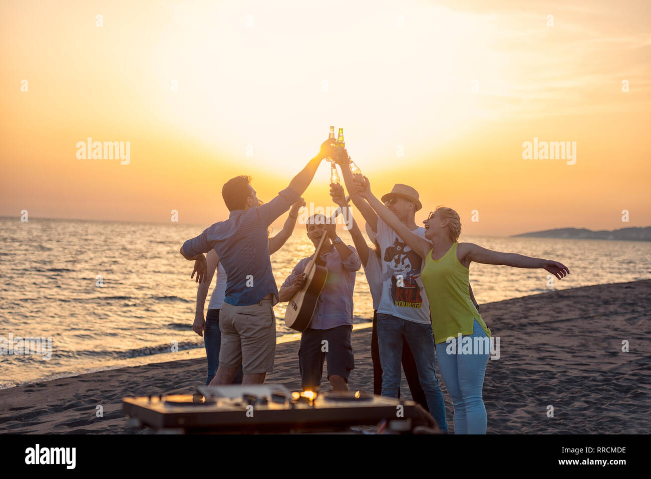 Group of friends enjoy on the beach Stock Photo - Alamy