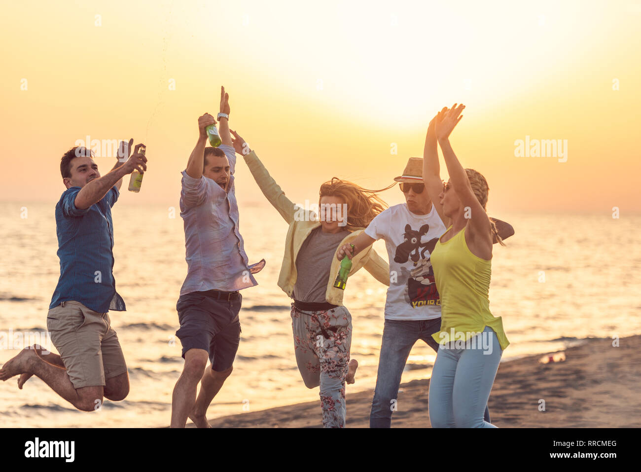 Group of friends enjoy on the beach Stock Photo - Alamy