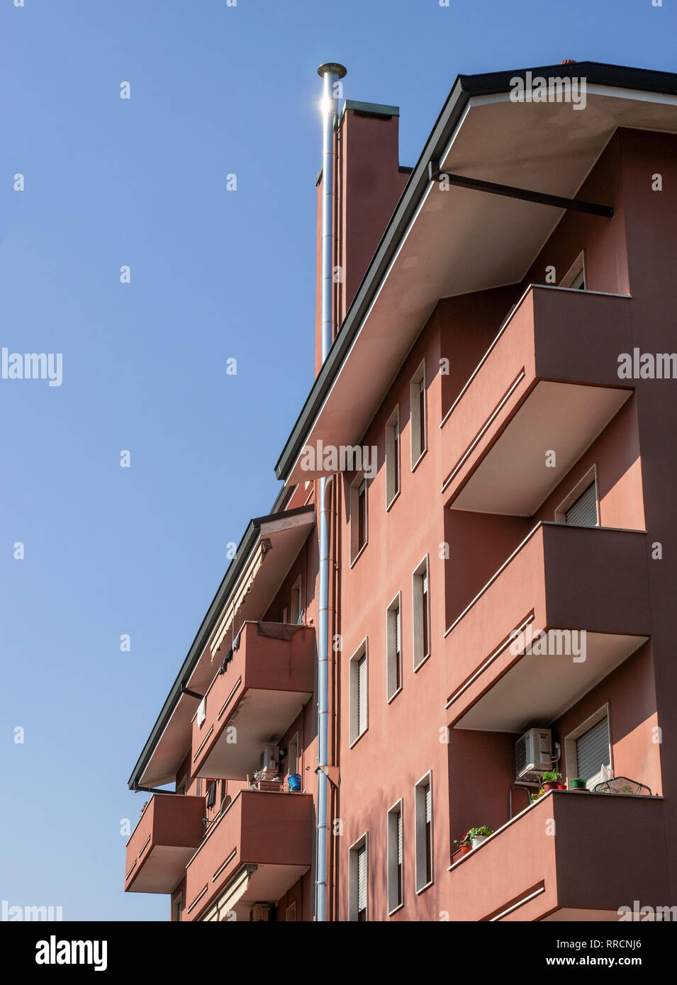 long outdoor steel chimney on the facade of a apartment building Stock ...