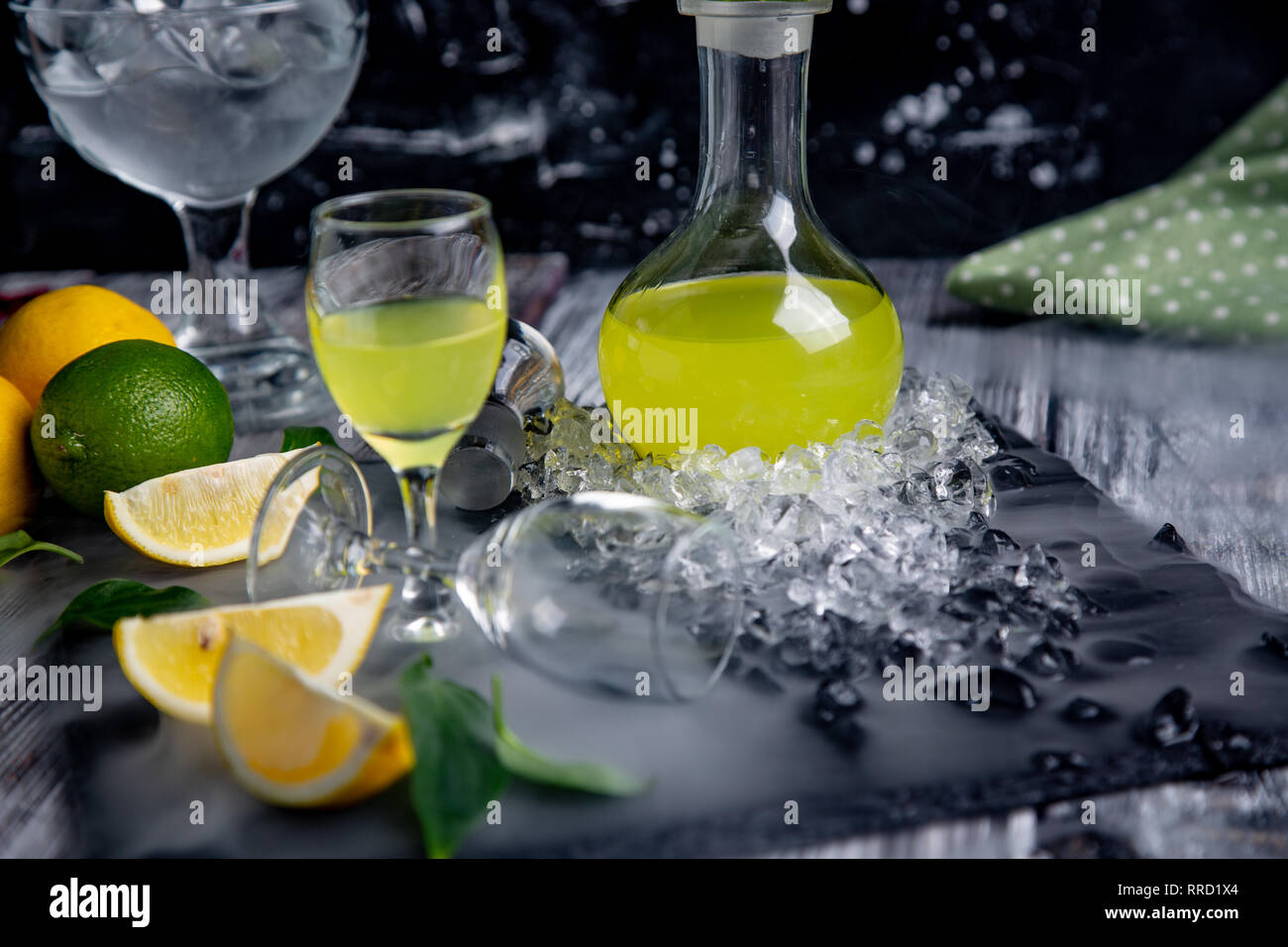 Italian typical digestive limoncello with fresh lemons in smoke ...