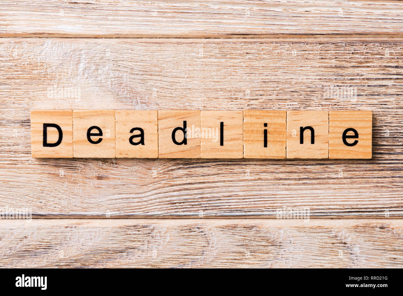 DEADLINE word written on wood block. DEADLINE text on wooden table for ...