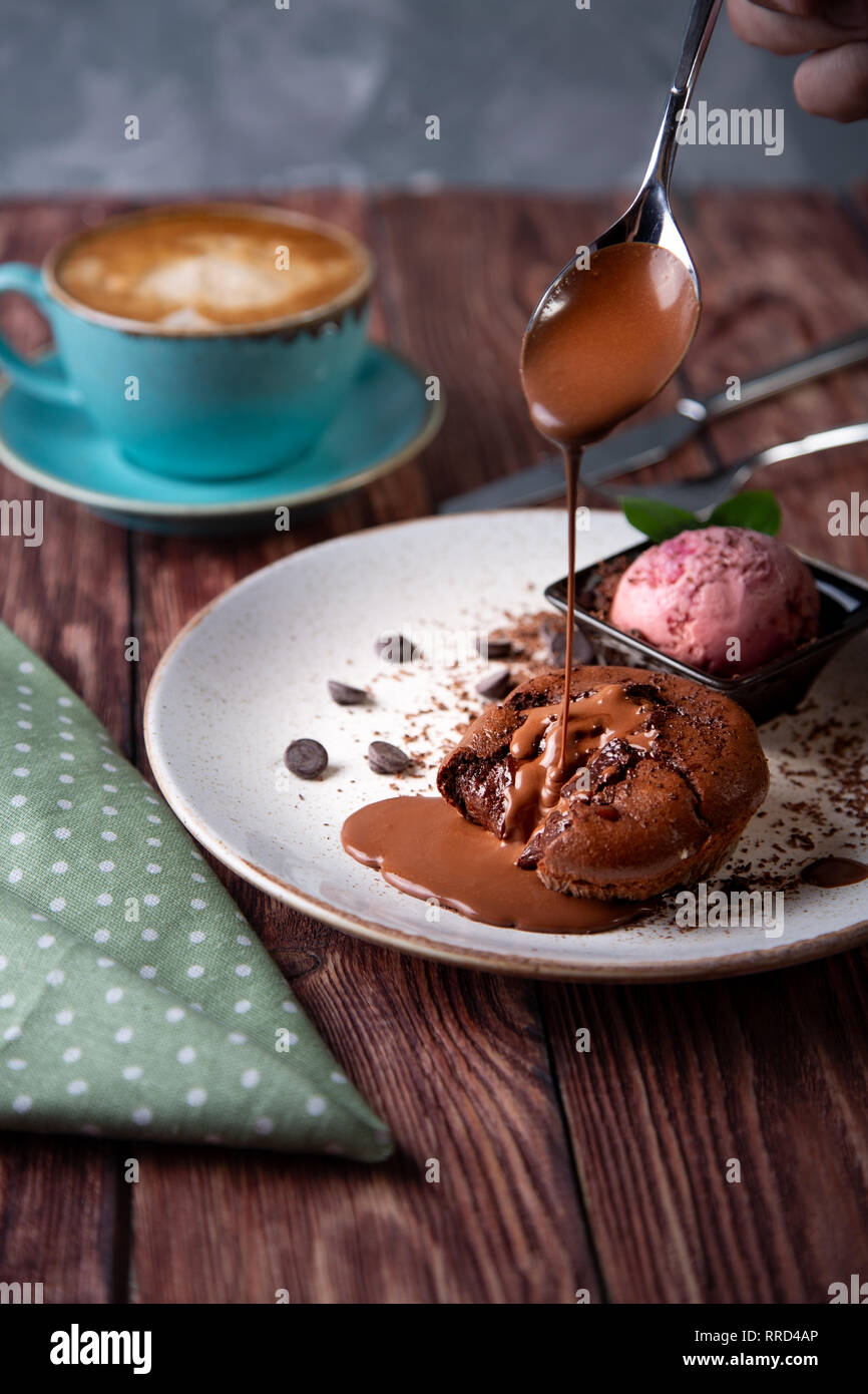 Chocolate lava cake Molten with ice cream on plate and cappuccino ...