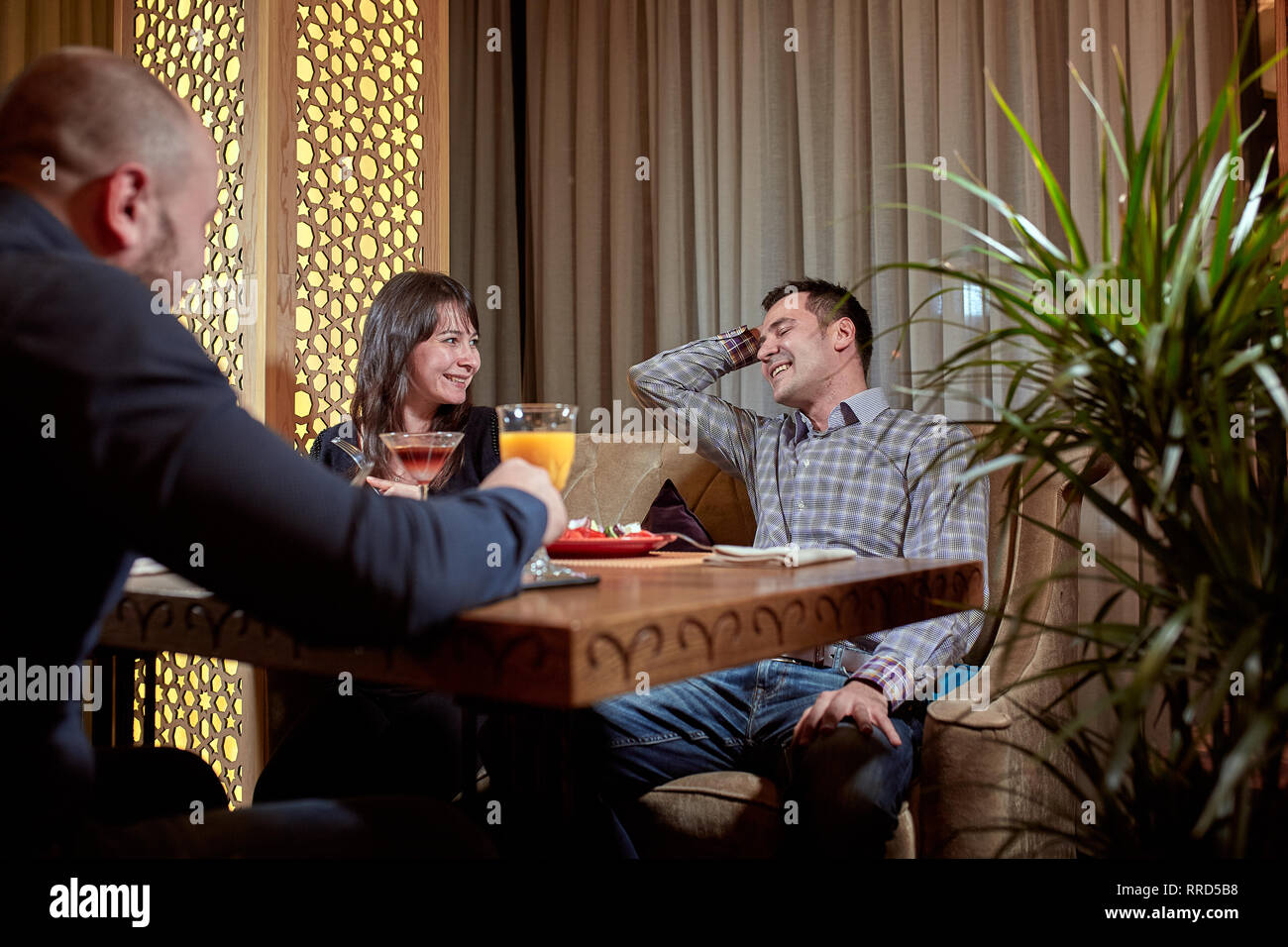 The third is superfluous. couple in love is having dinner in a ...