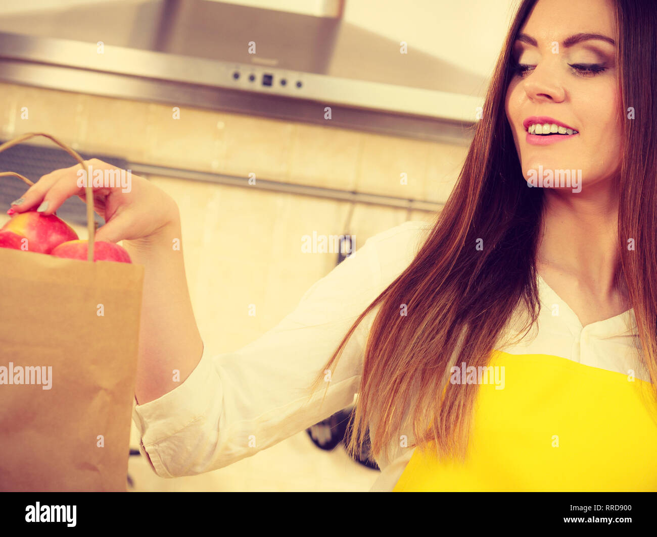 Woman attractive housewife in kitchen with grocery shopping bag, many ...