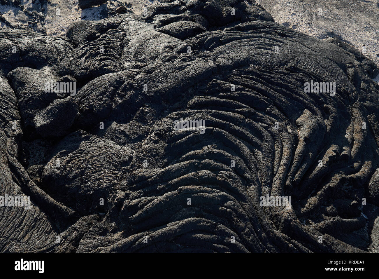 Closeup texture of dark rough rock in sunlight Stock Photo - Alamy