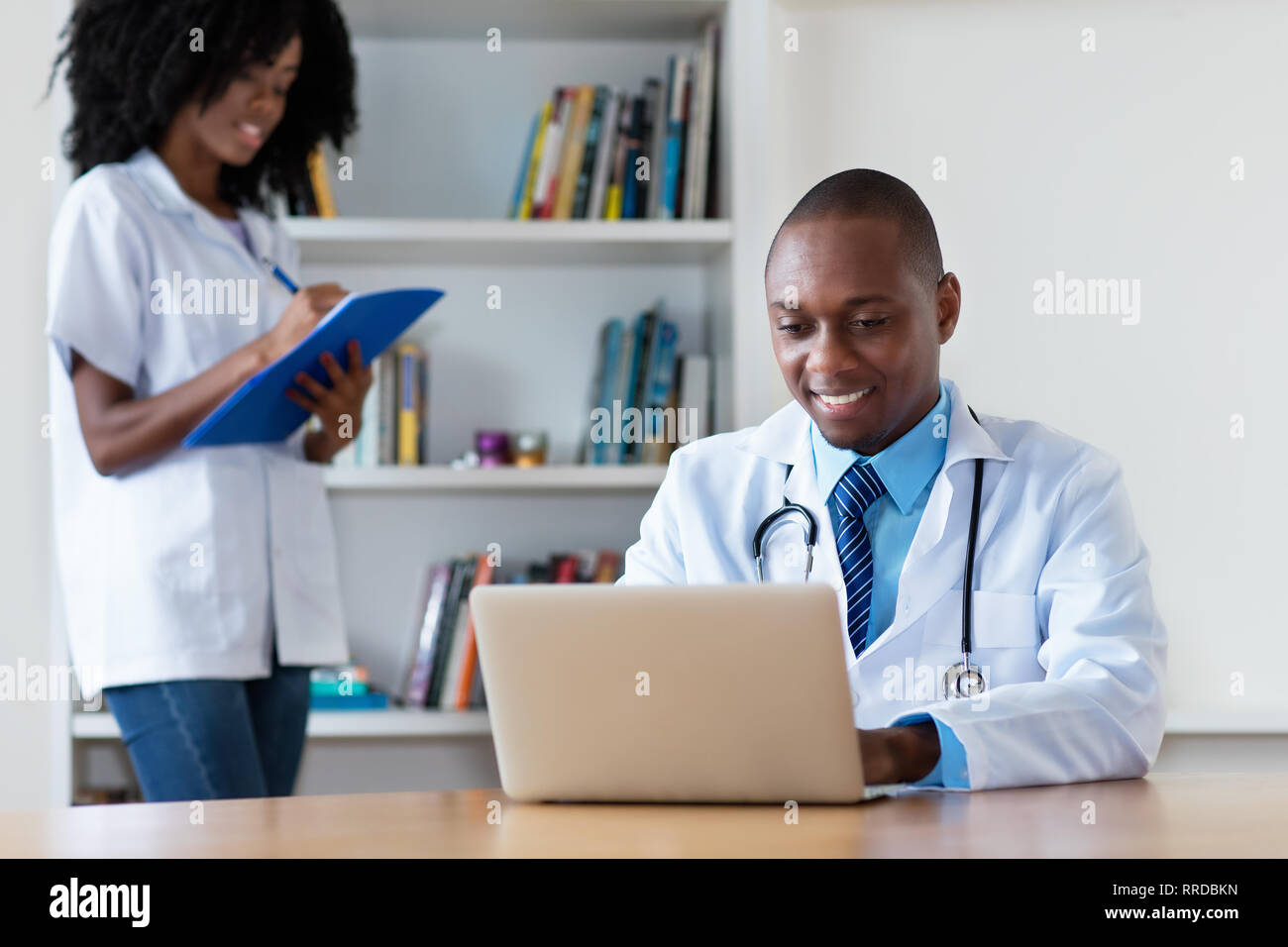 African american male doctor with nurse at work at hospital Stock Photo ...