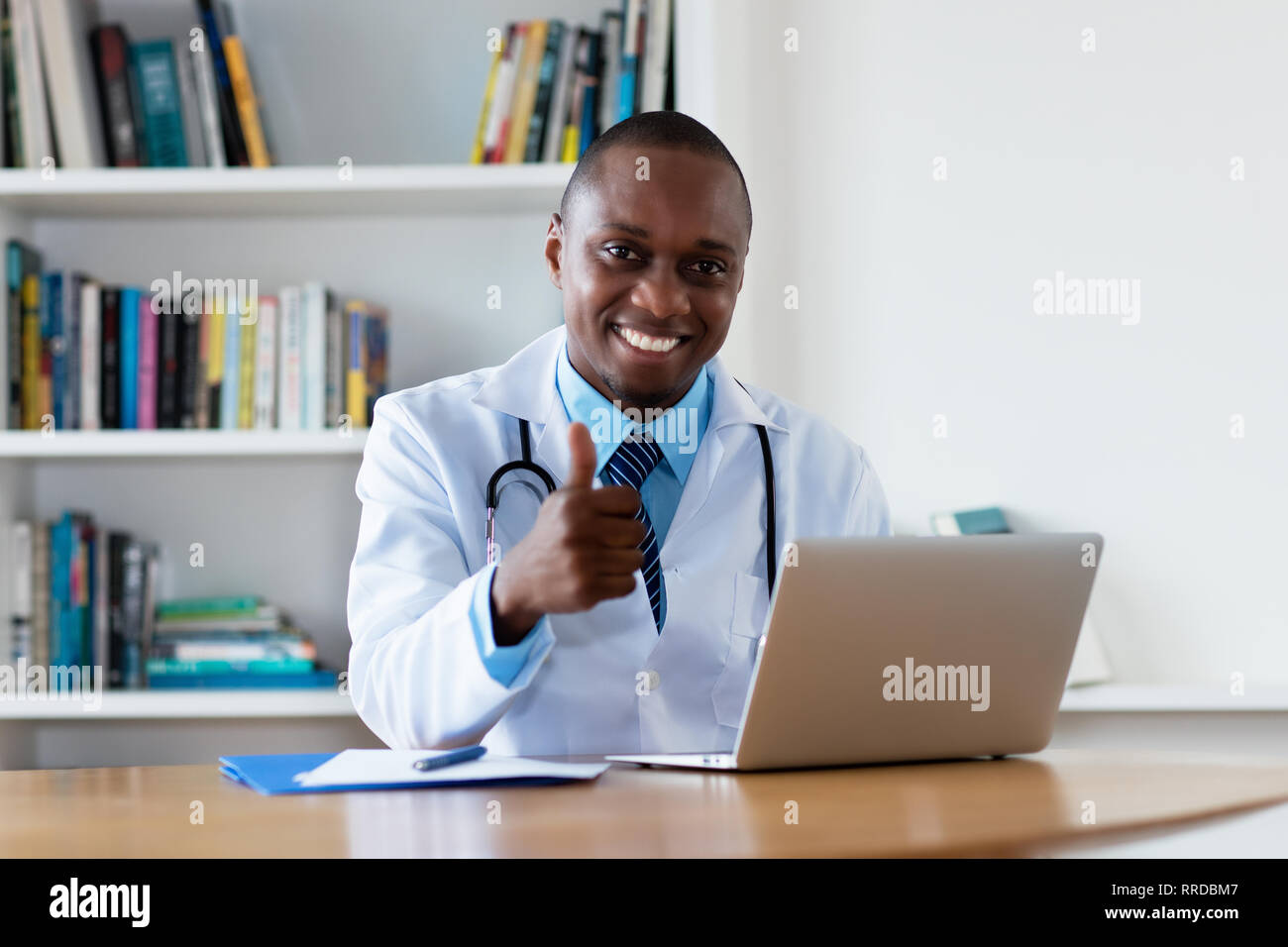 Friendly head physician working at computer at hospital Stock Photo - Alamy