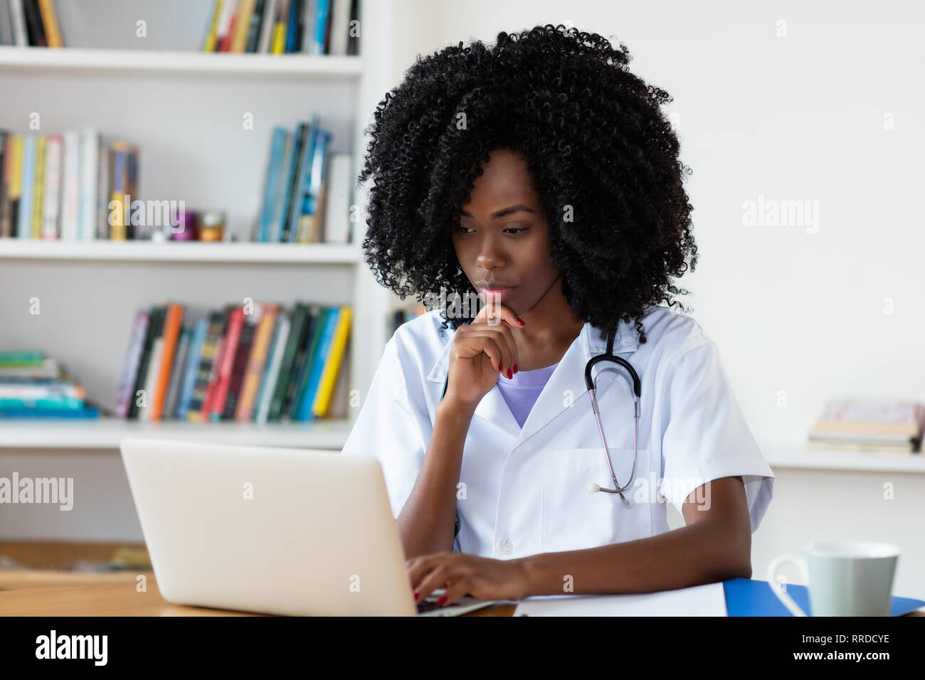African american medical student learning at computer at hospital Stock ...