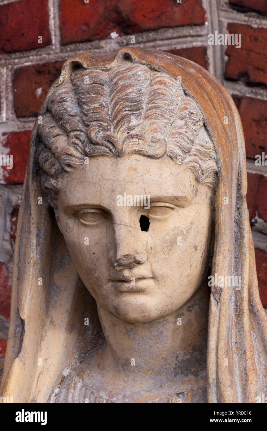 Holy Mary statue portrait. Ancient statue near a brick wall Stock Photo ...