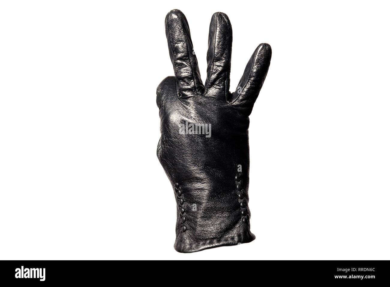 Close-up black leather glove, fingers showing number three. Isolated on ...