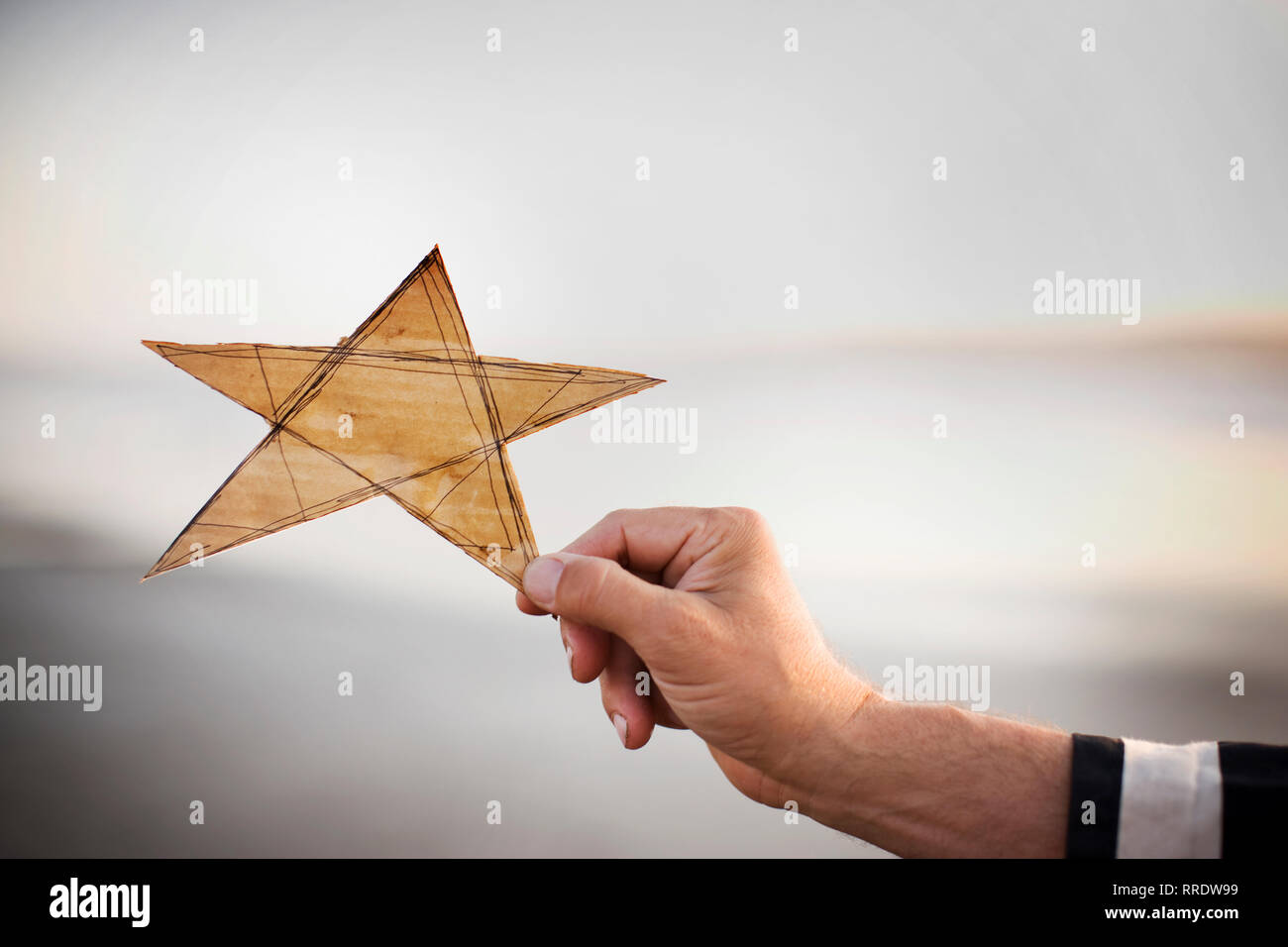 Paper star being held up Stock Photo - Alamy