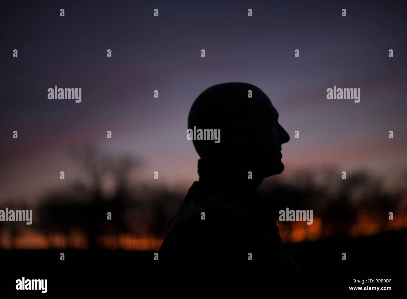 Man standing outdoors at sunset Stock Photo - Alamy