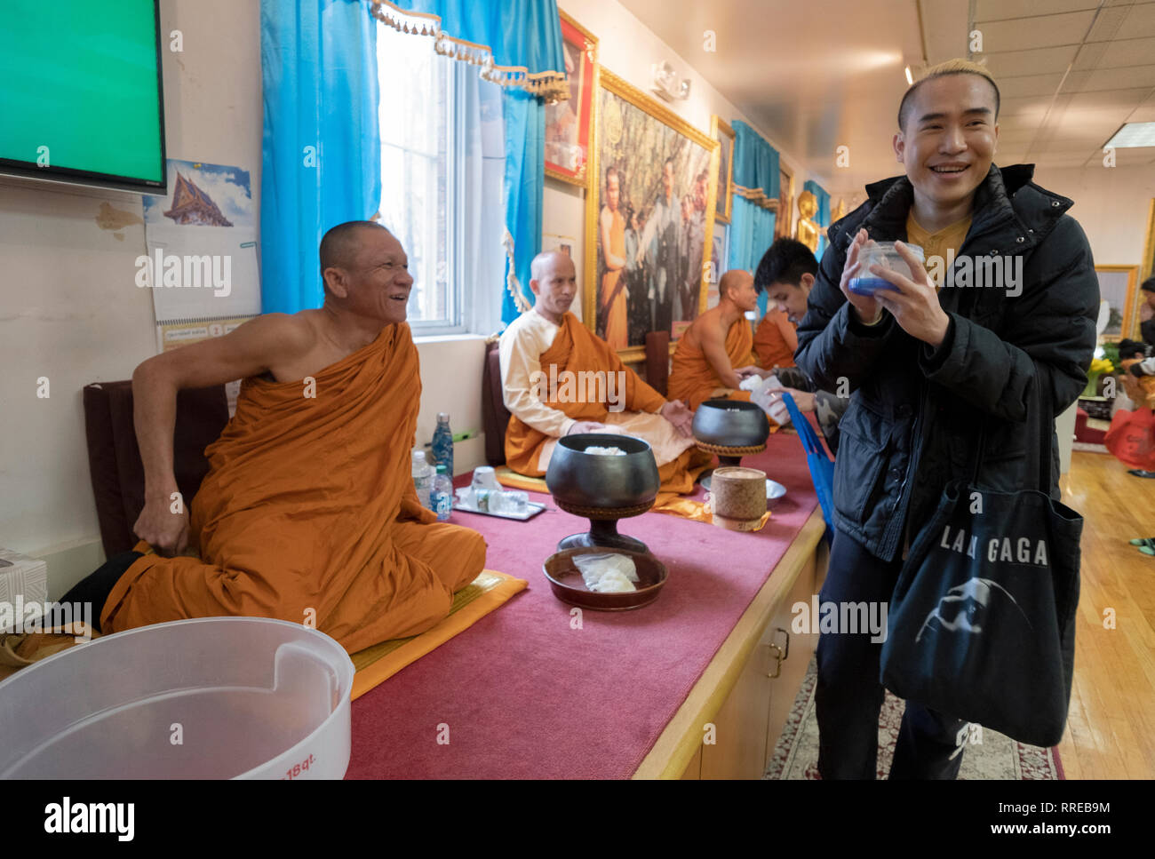 A Buddhist worshipper shares a pleasant moment with a monk after ...