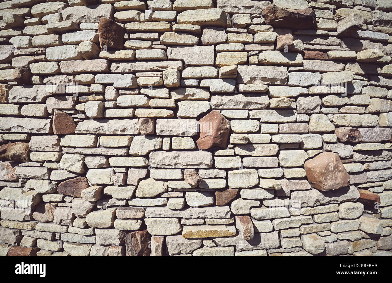 Old stone wall background, color toning applied Stock Photo - Alamy