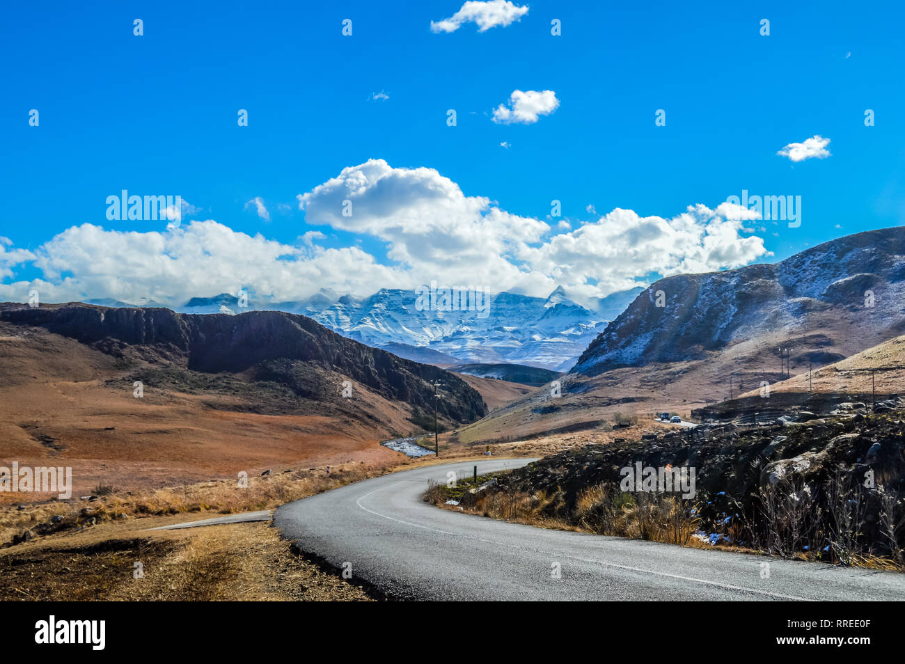 Picture perfect snow capped Drakensberg mountains and green plains in ...