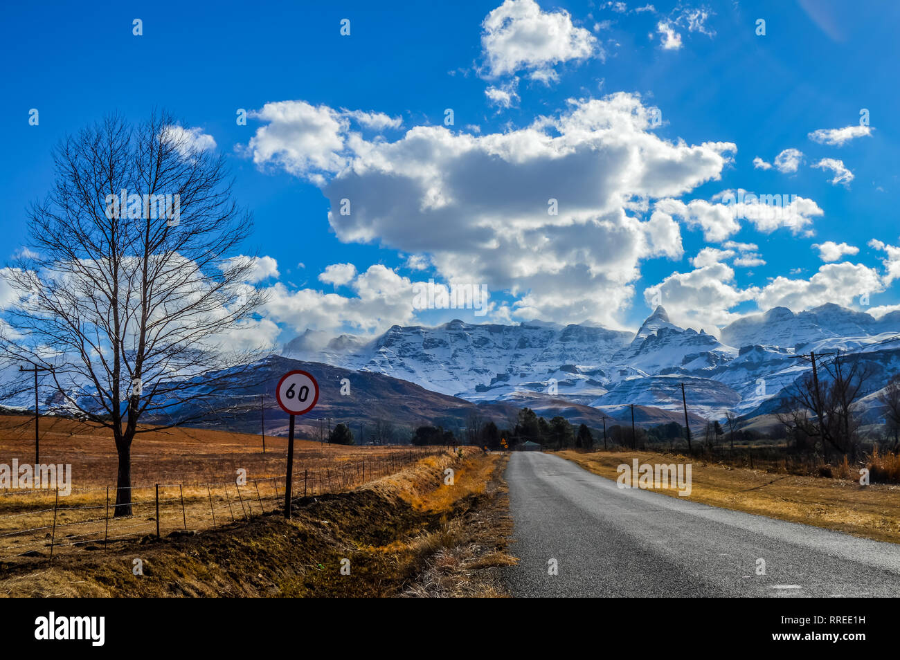 Picture perfect snow capped Drakensberg mountains and green plains in ...