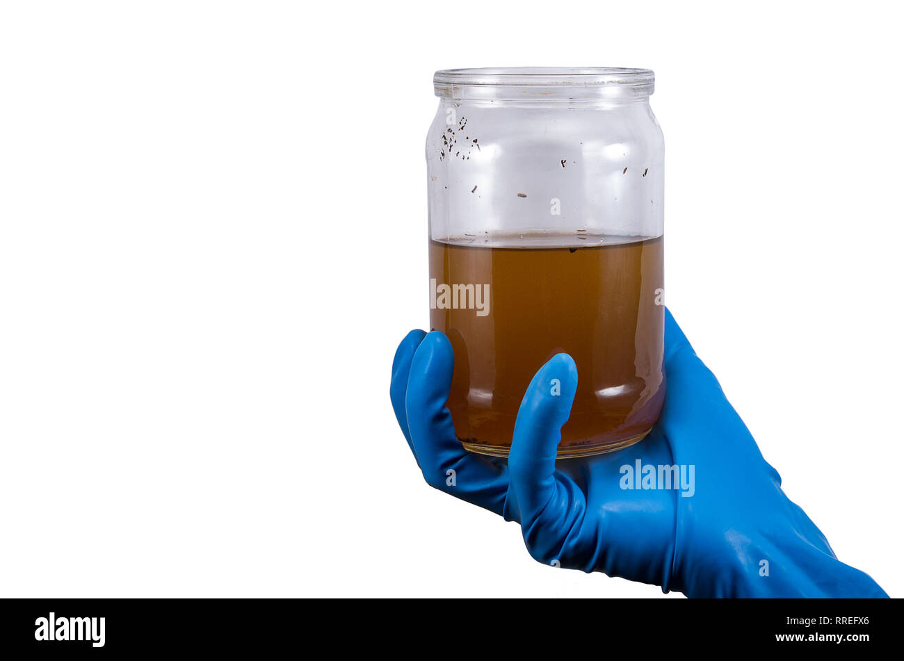 dirty contaminated infectious water in a jar in hand rubber glove ...