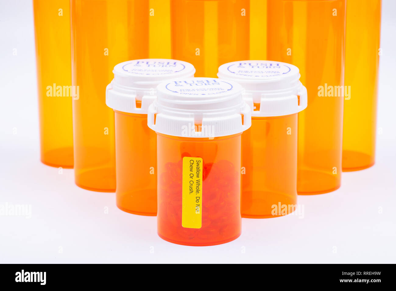 Docusate sodium soft gel capsules in orange container with SWALLOW ...