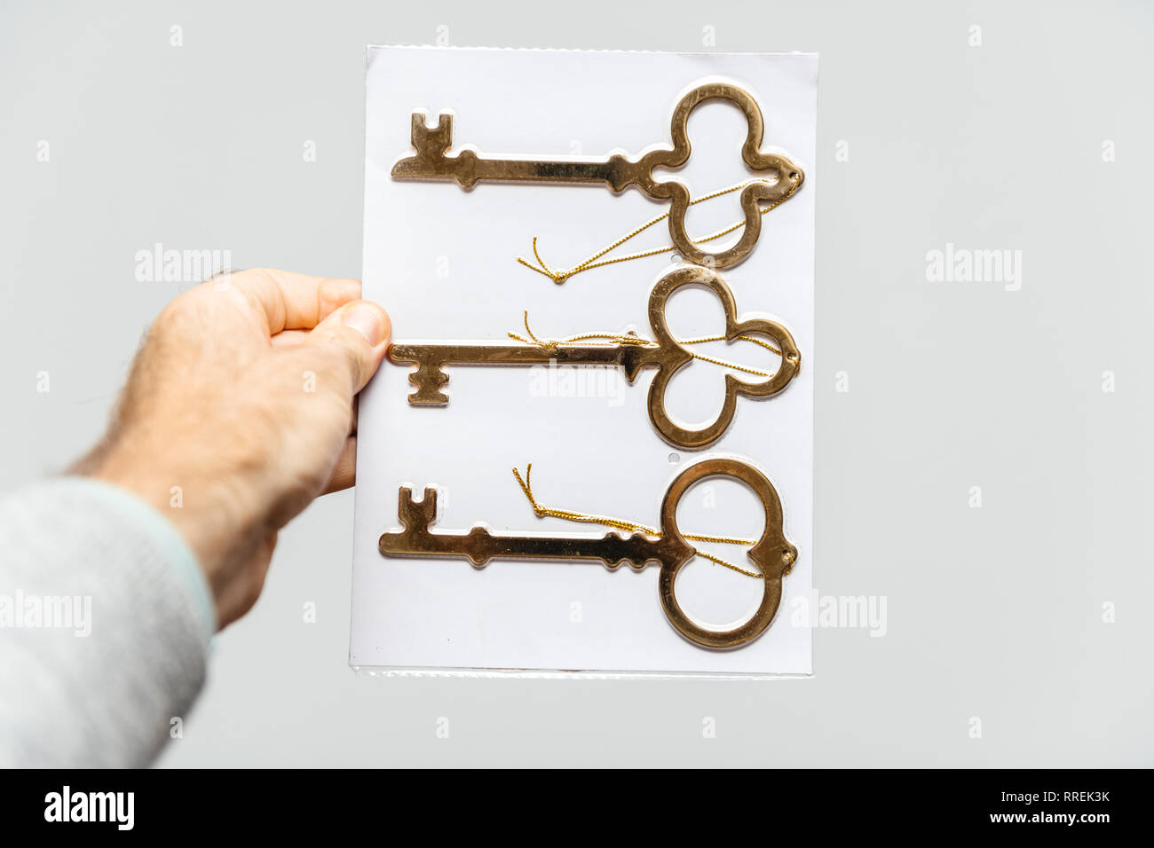 Man holding against white background a set of three vintage ancient ...