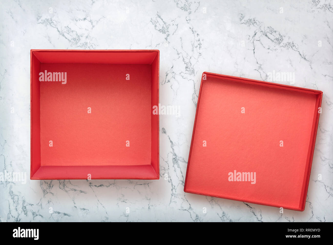 Flat lay of empty red gift box with lid on natural marble background ...