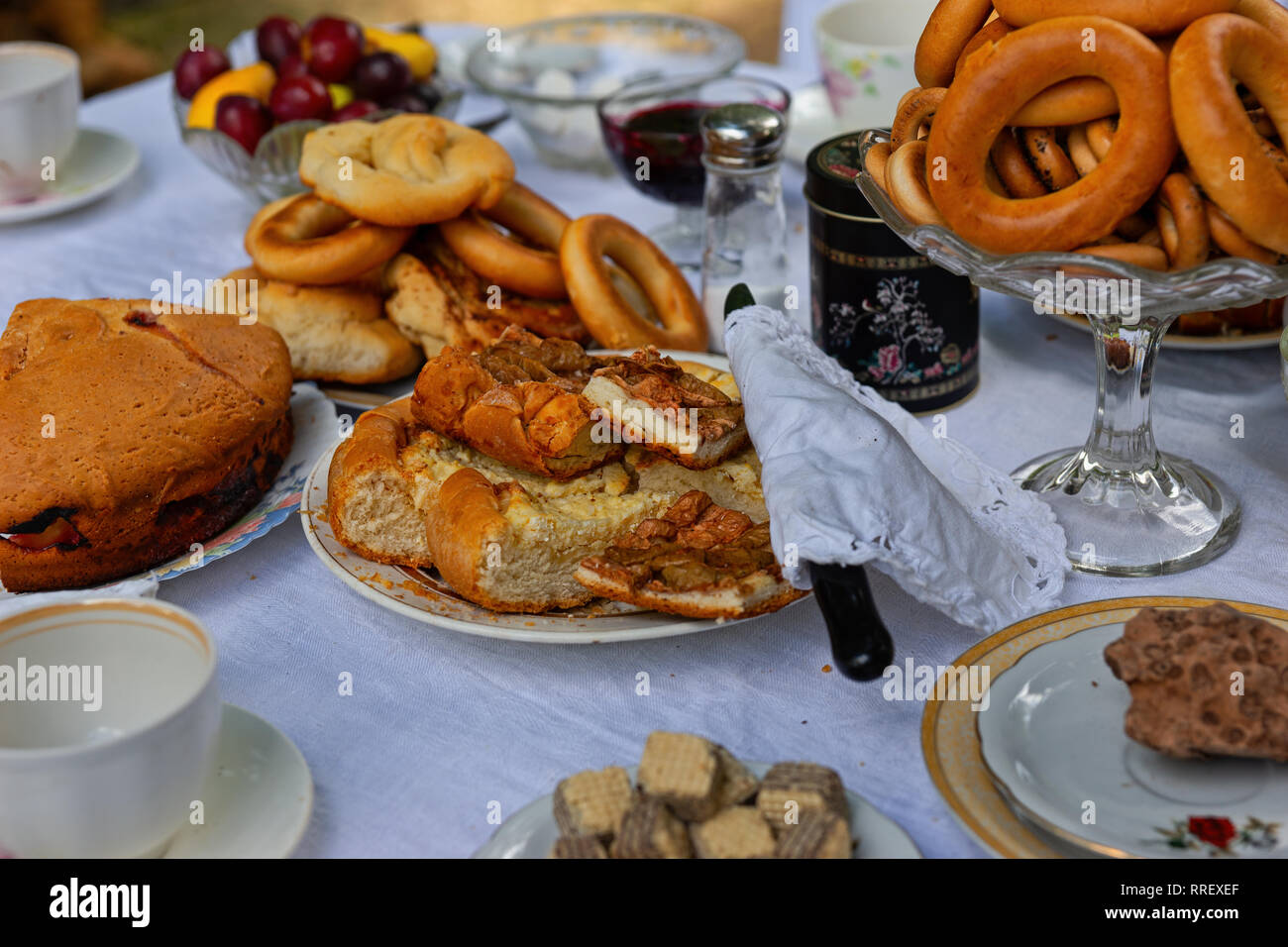 Details of a tea table. Tea service, utensils, plates, and vases filled ...