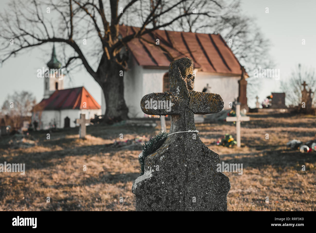 Old Tombstones in public cemetery in European village with chapel on ...