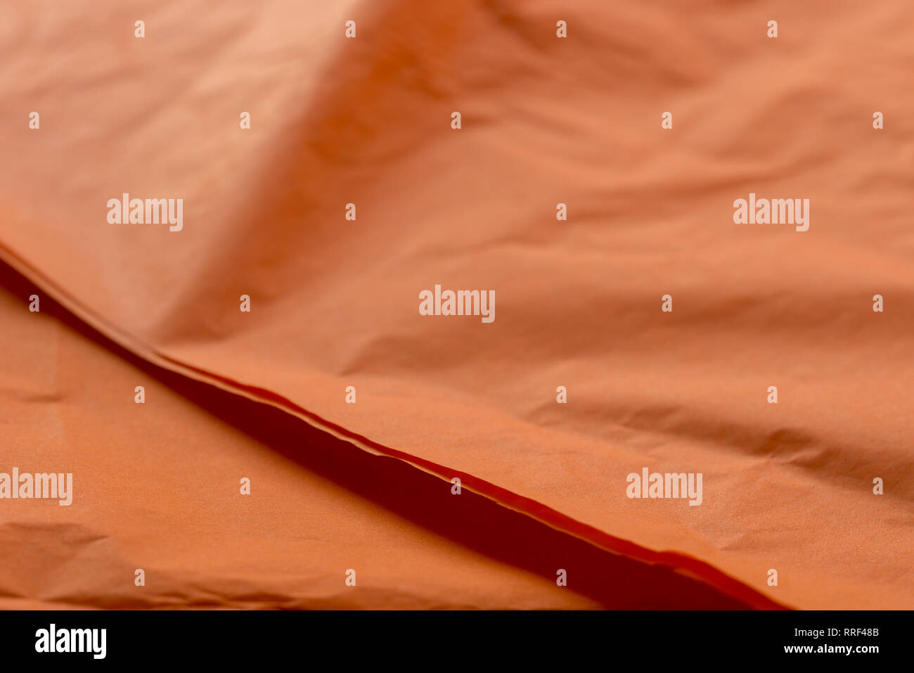 orange color creased paper tissue background texture Stock Photo - Alamy