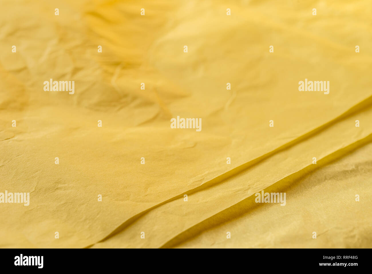 yellow color creased paper tissue background texture Stock Photo - Alamy