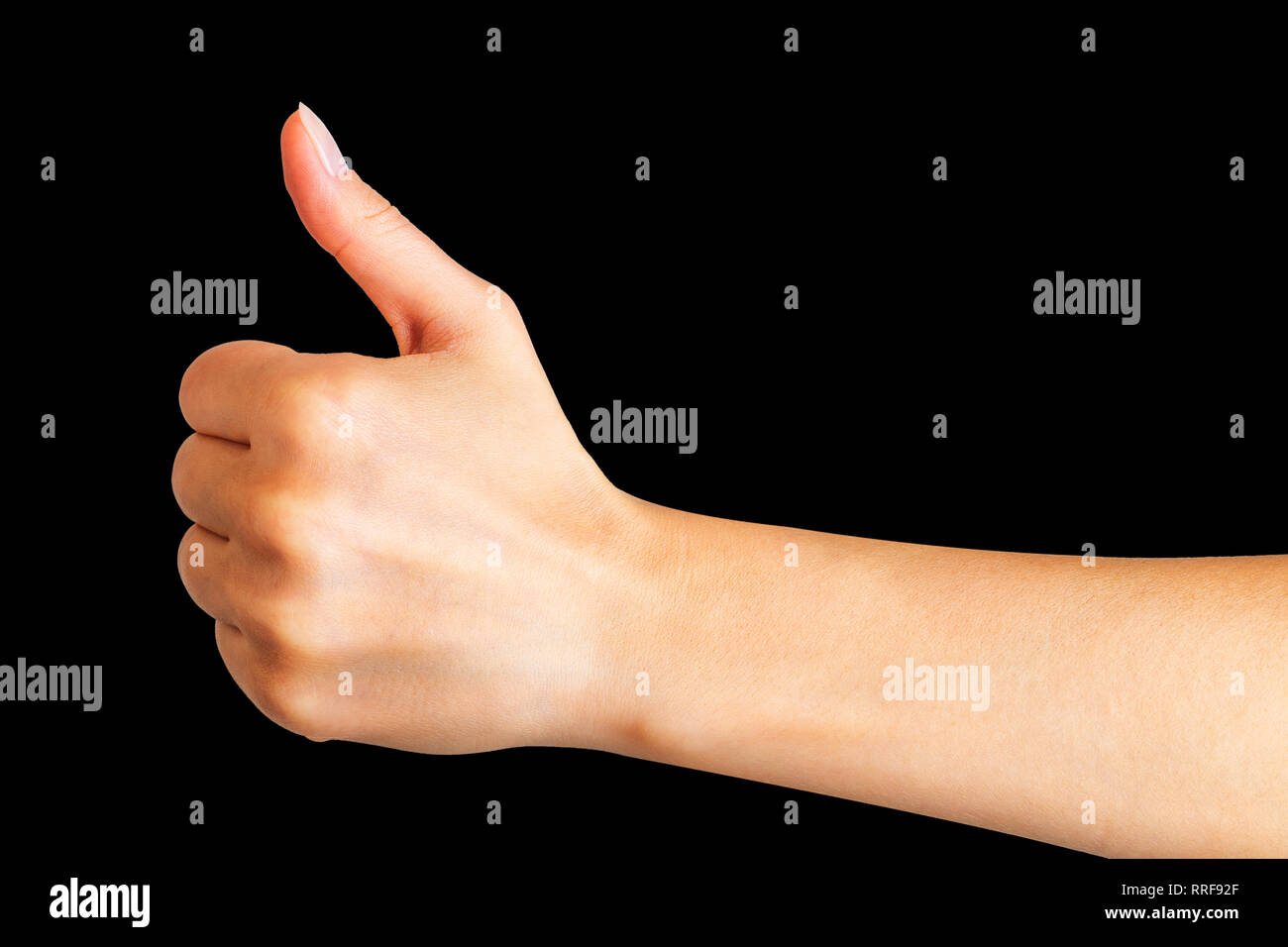 Woman holding hand in gesture of like sign, giving thumb up Stock Photo ...
