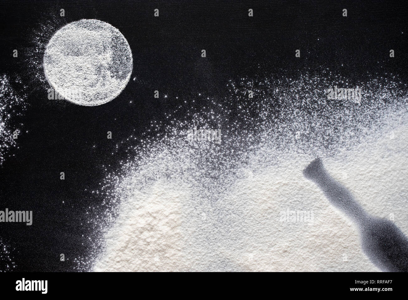 Flour on black background Stock Photo - Alamy