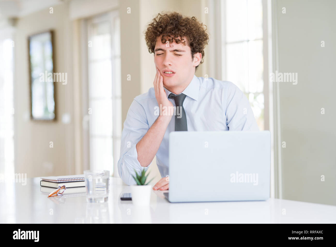 Young business man working with computer laptop at the office touching ...