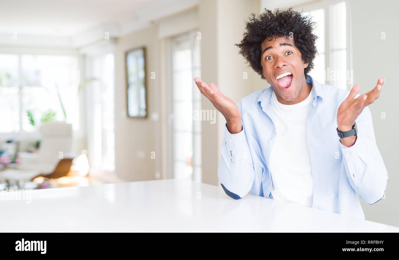 African American man at home celebrating crazy and amazed for success ...