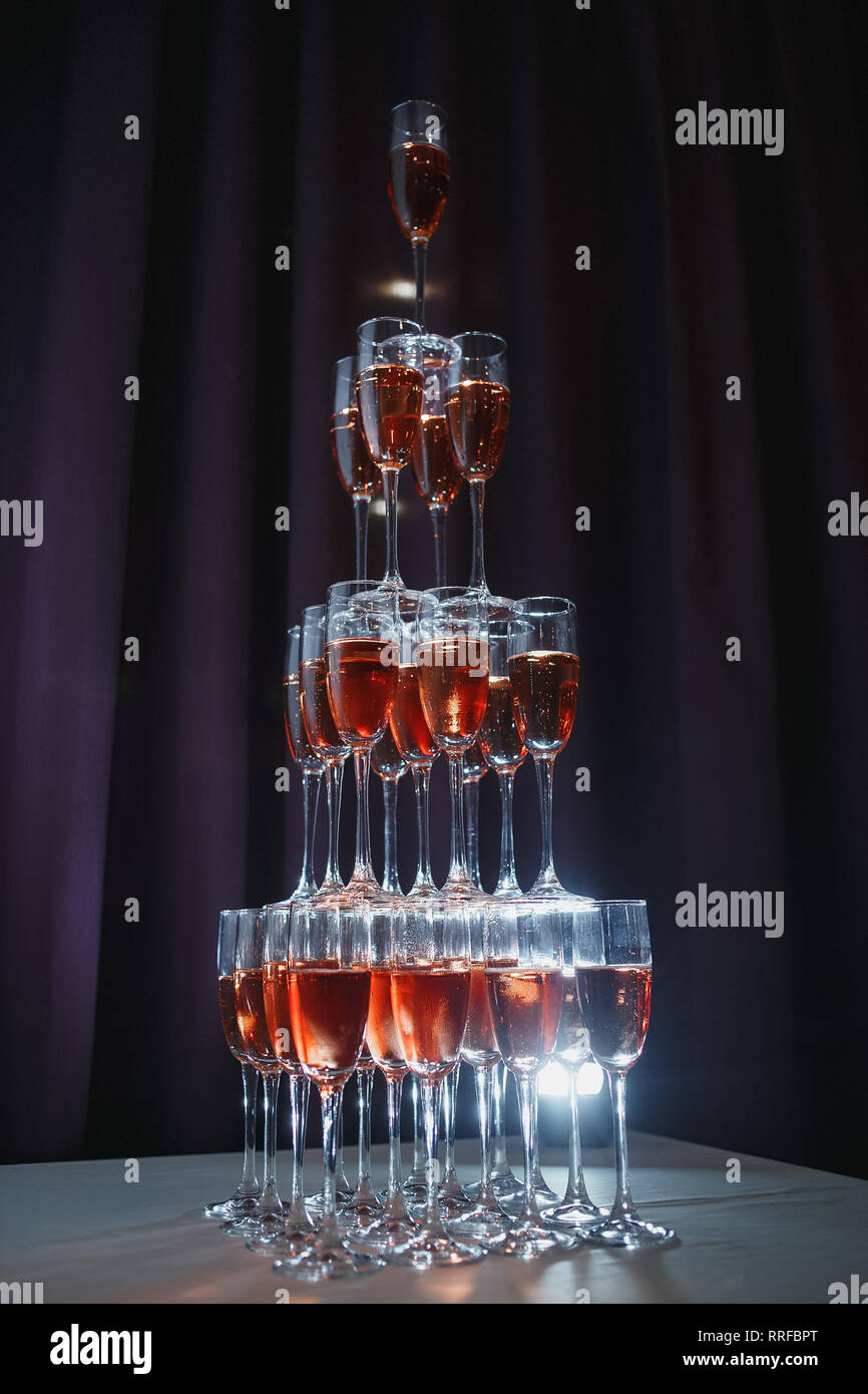 Pyramid from glasses with red sparkling wine Stock Photo - Alamy