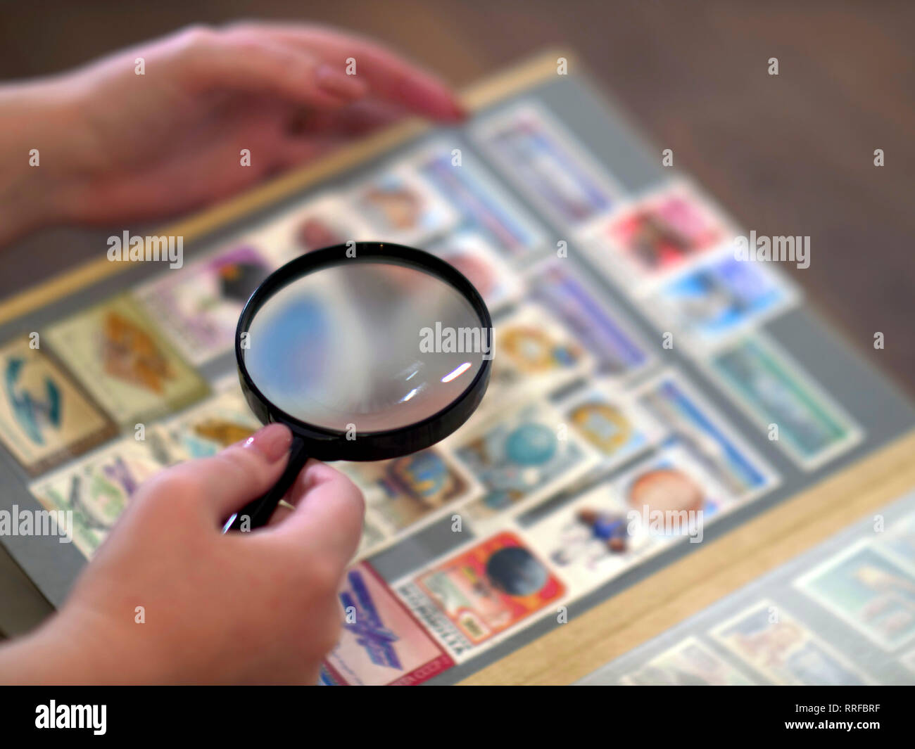 magnifier stamps album hand Stock Photo - Alamy
