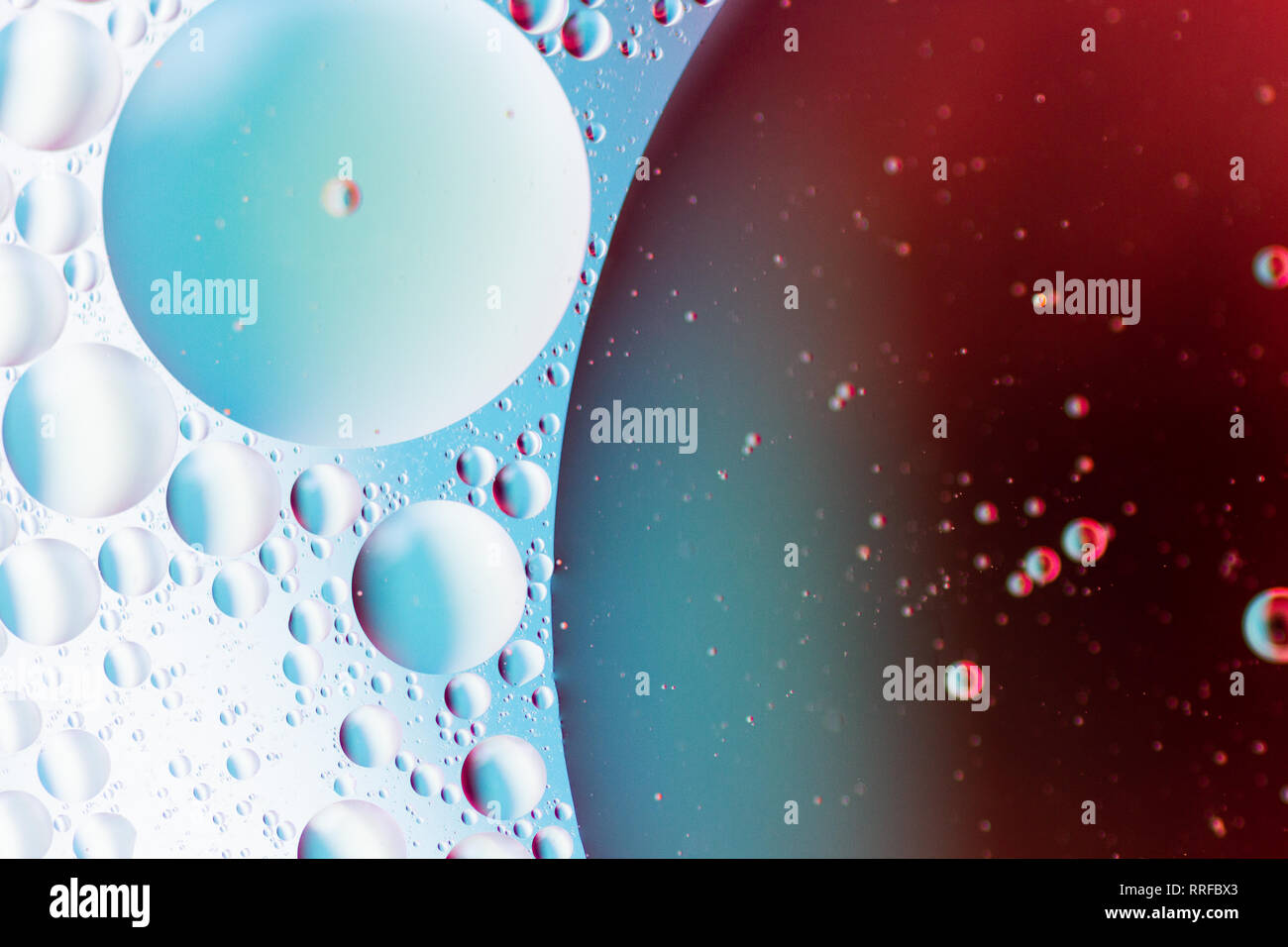 From above closeup many abstract red and blue water bubbles on glass on ...