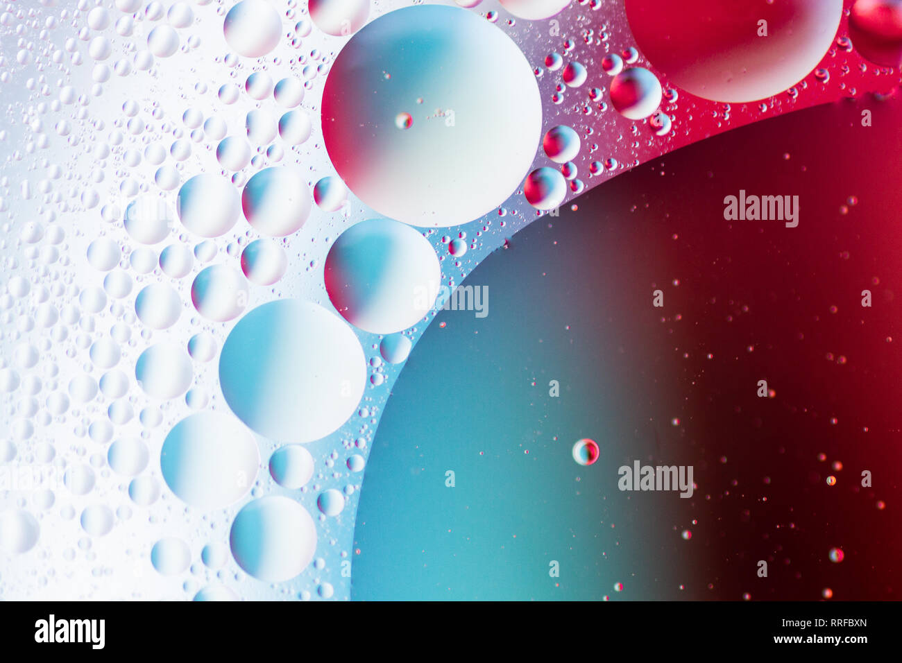 From above closeup many abstract red and blue water bubbles on glass on ...