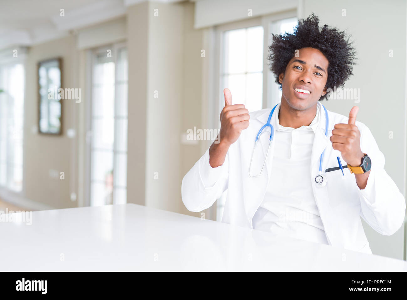African American doctor man at the clinic success sign doing positive ...