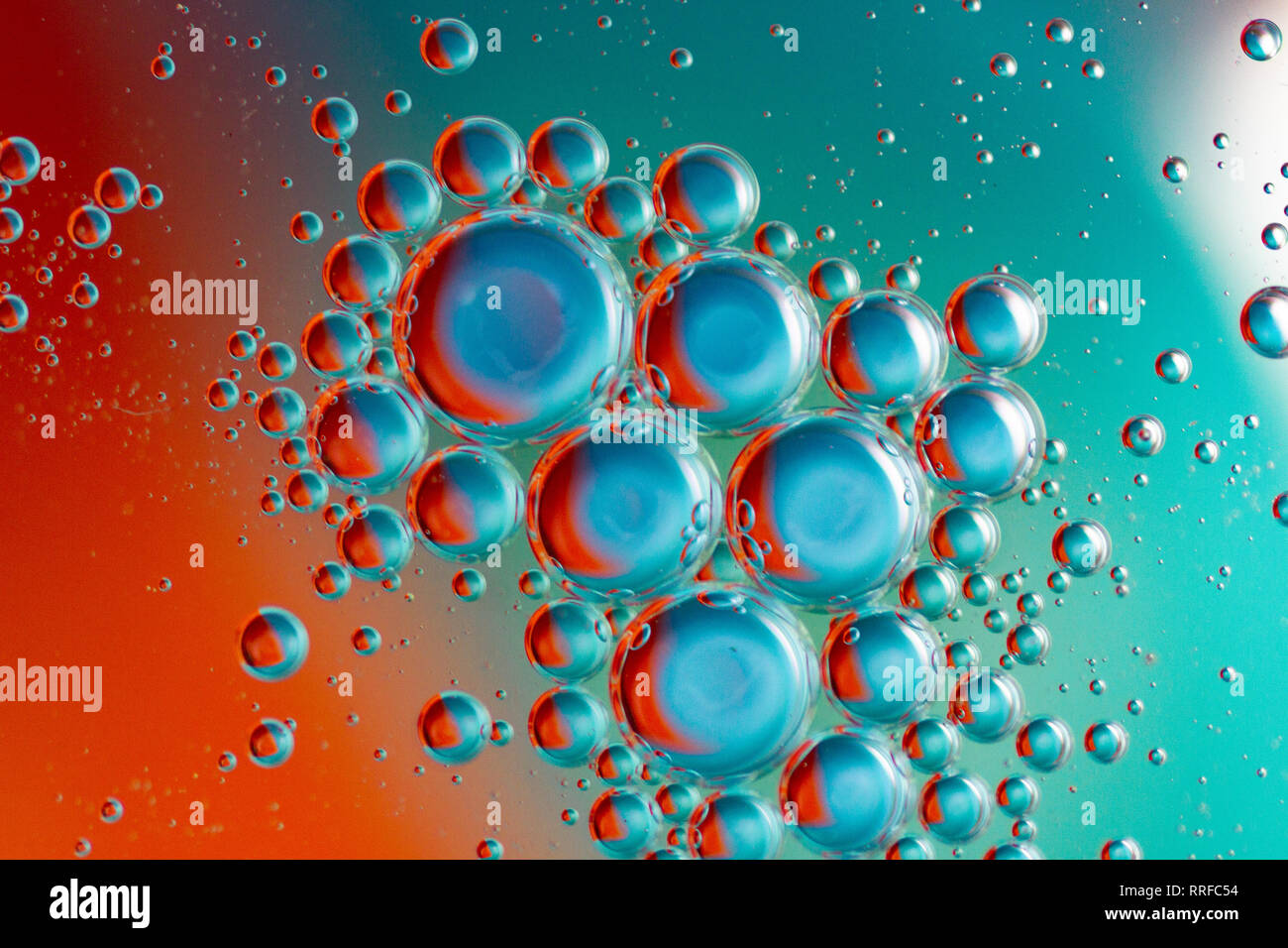 From above closeup many abstract red and blue water bubbles on glass on ...