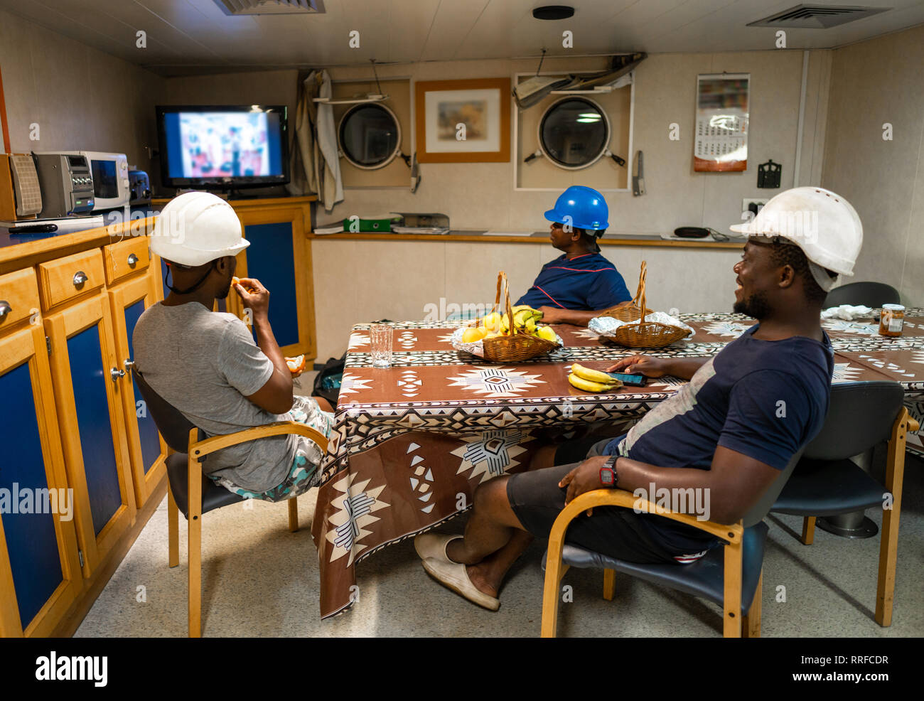 Seamen crew onboard a ship or vessel having fun watching TV Stock Photo ...