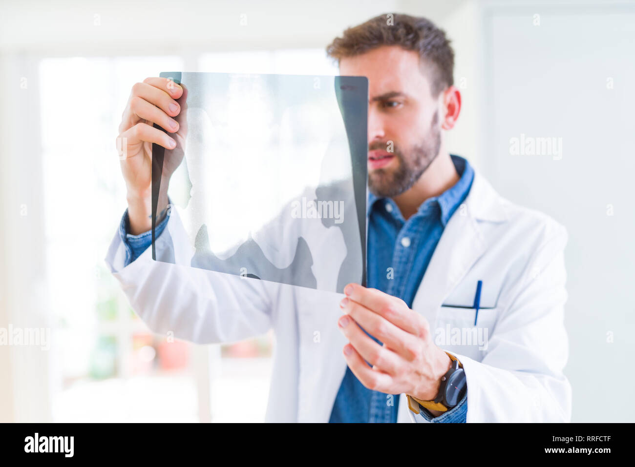 Doctor man looking at x-ray radiography doing body examination Stock ...