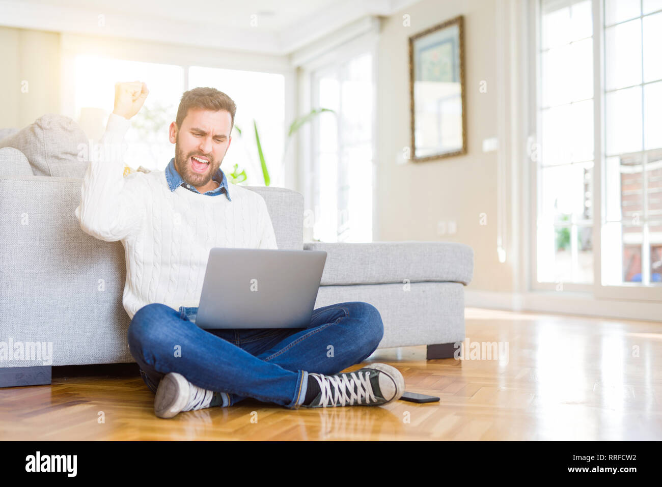 Handsome man wearing working using computer laptop annoyed and ...