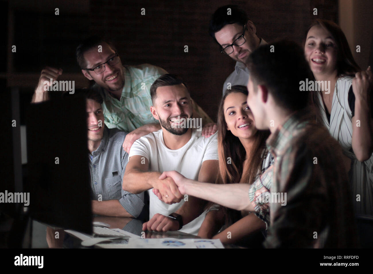 business colleagues shaking hands at the Desk Stock Photo - Alamy