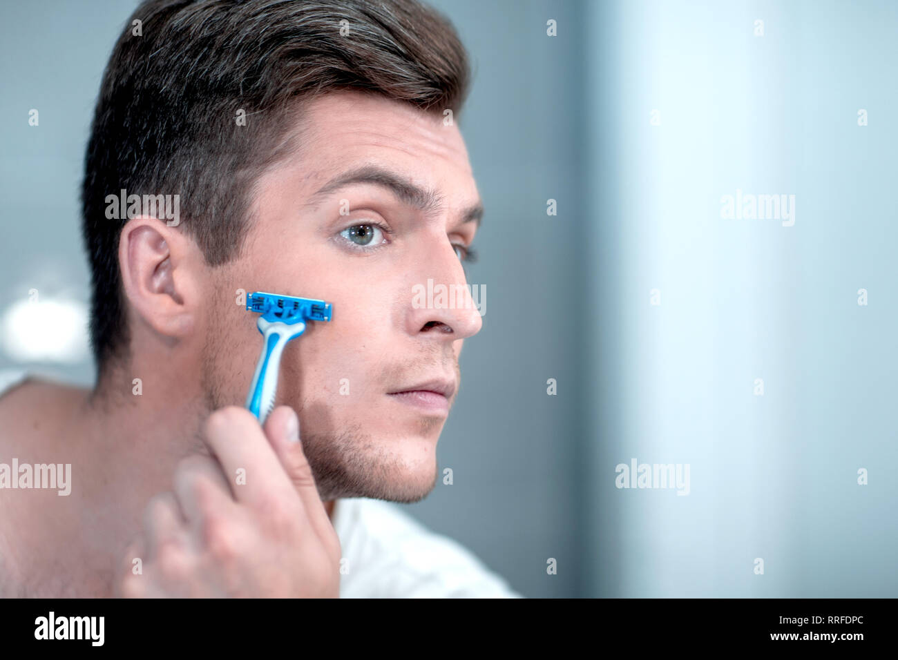 close up. stylish young man shaves his face Stock Photo - Alamy