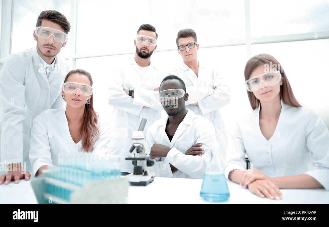 Group of young successful scientists posing for camera Stock Photo - Alamy