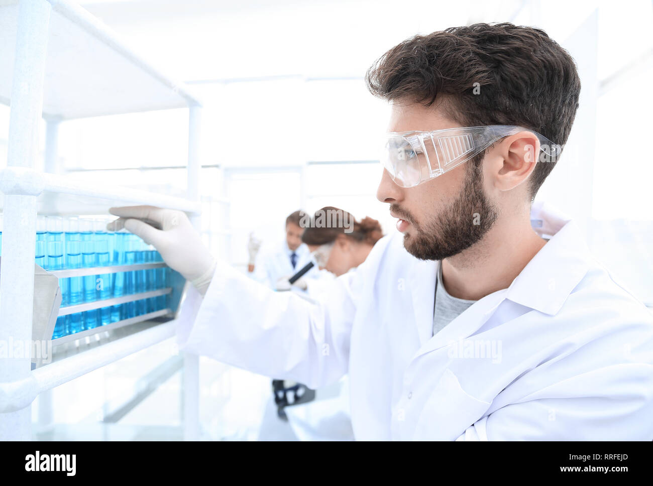 side view of focused scientist holding test tube in laboratory Stock ...