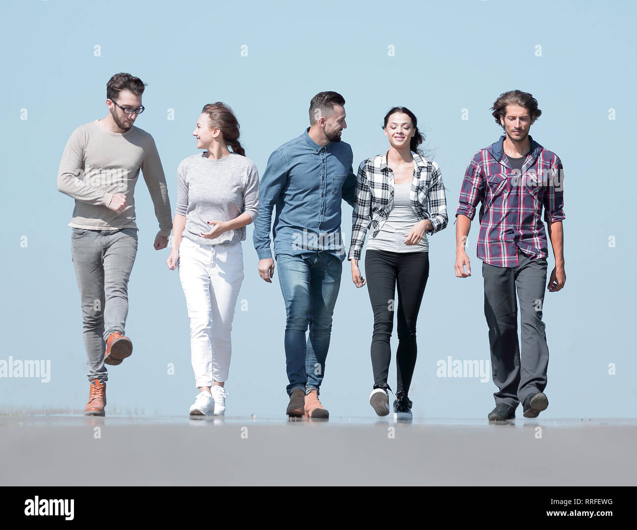 team of young people walking along the road.outdoors Stock Photo - Alamy